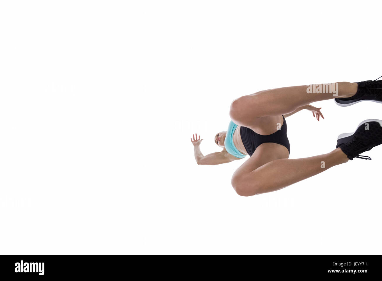 Low angle female athlete jumping Stock Photo - Alamy