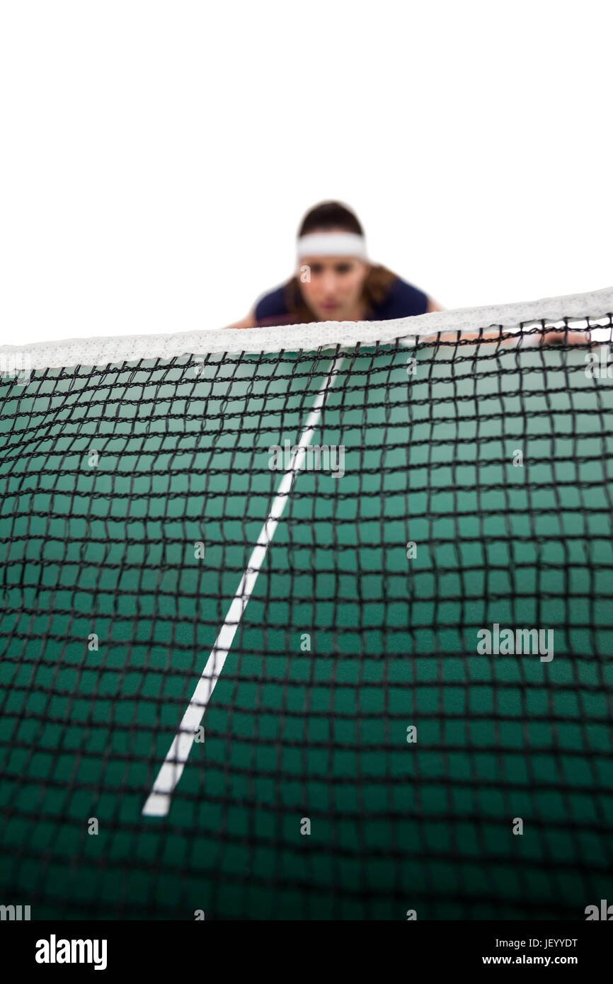 Tennis player behind net Stock Photo - Alamy