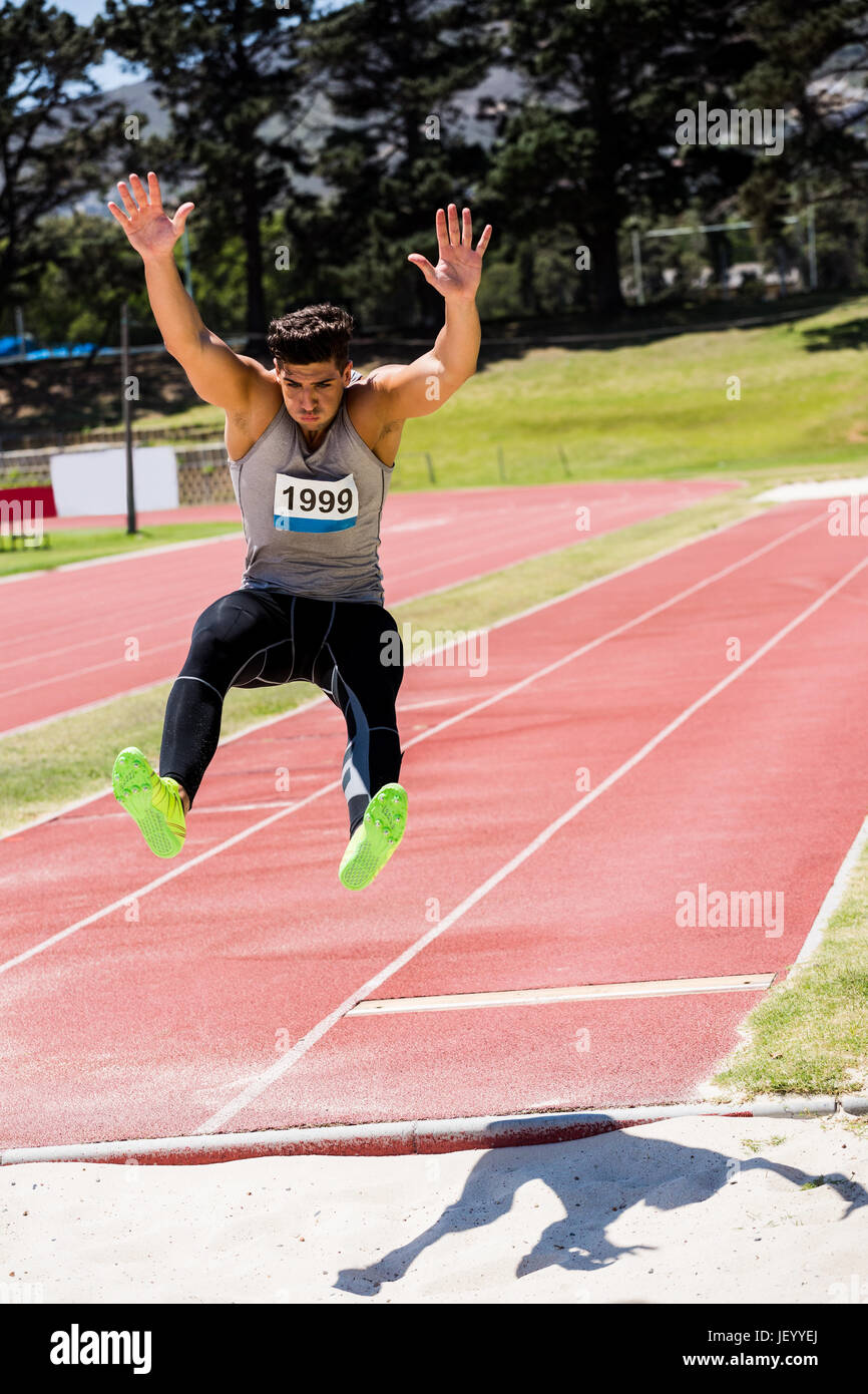 Athlete performing a long jump Stock Photo - Alamy