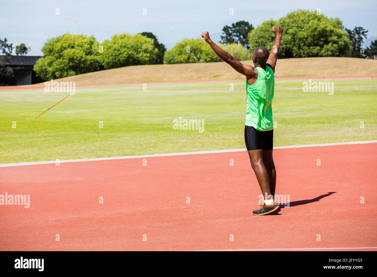 Rear view of athlete posing after victory Stock Photo - Alamy