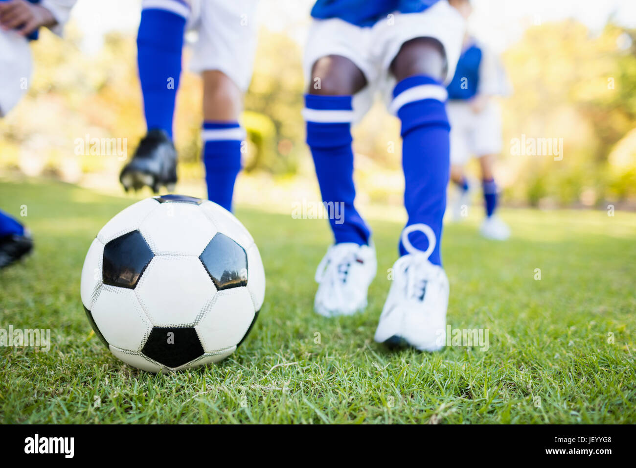 Mixed race children playing football hi-res stock photography and ...