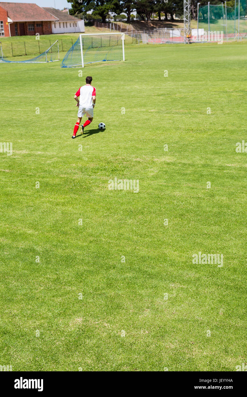 Football player practicing soccer Stock Photo - Alamy