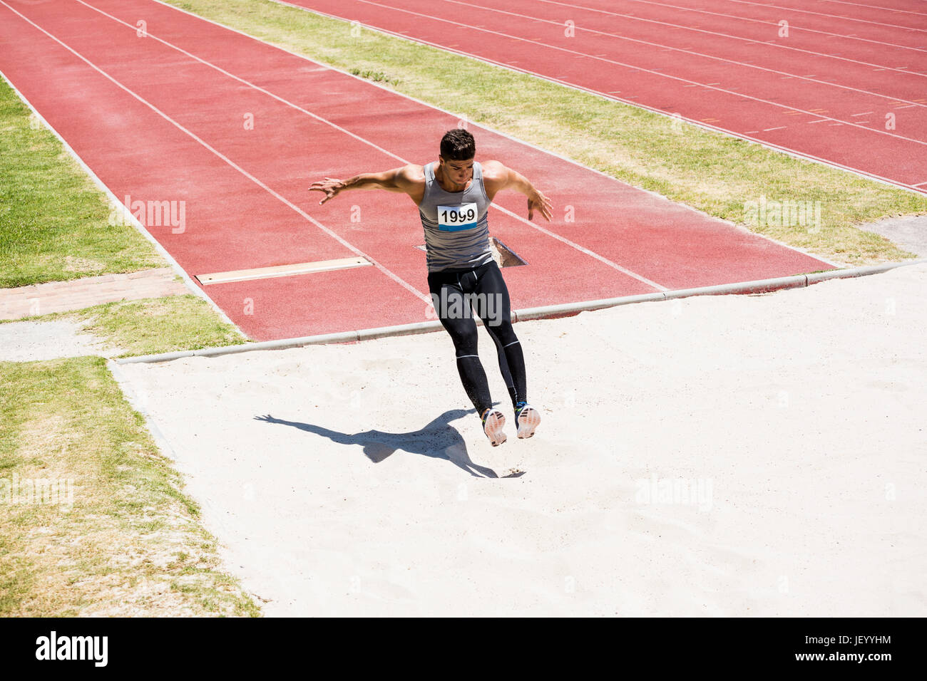 Athlete performing a long jump Stock Photo - Alamy