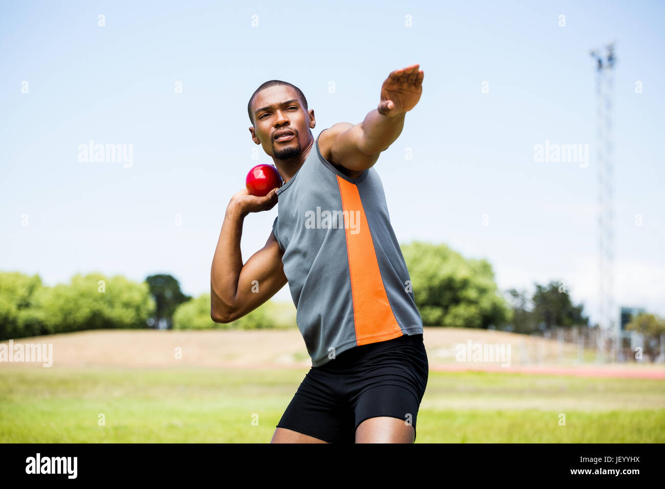 Male athlete about to throw shot put ball Stock Photo - Alamy