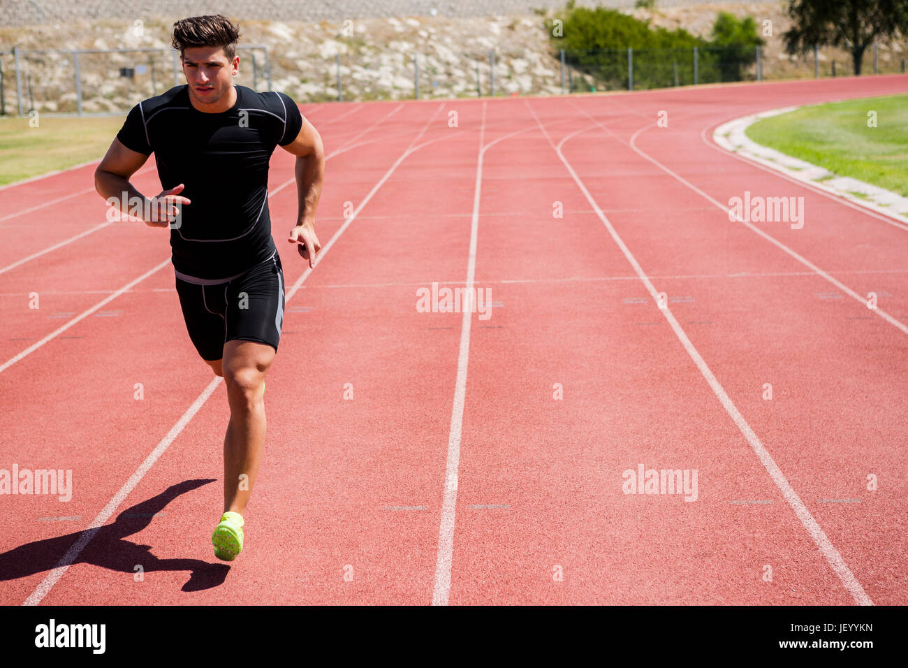 Athlete running on the racing track Stock Photo - Alamy