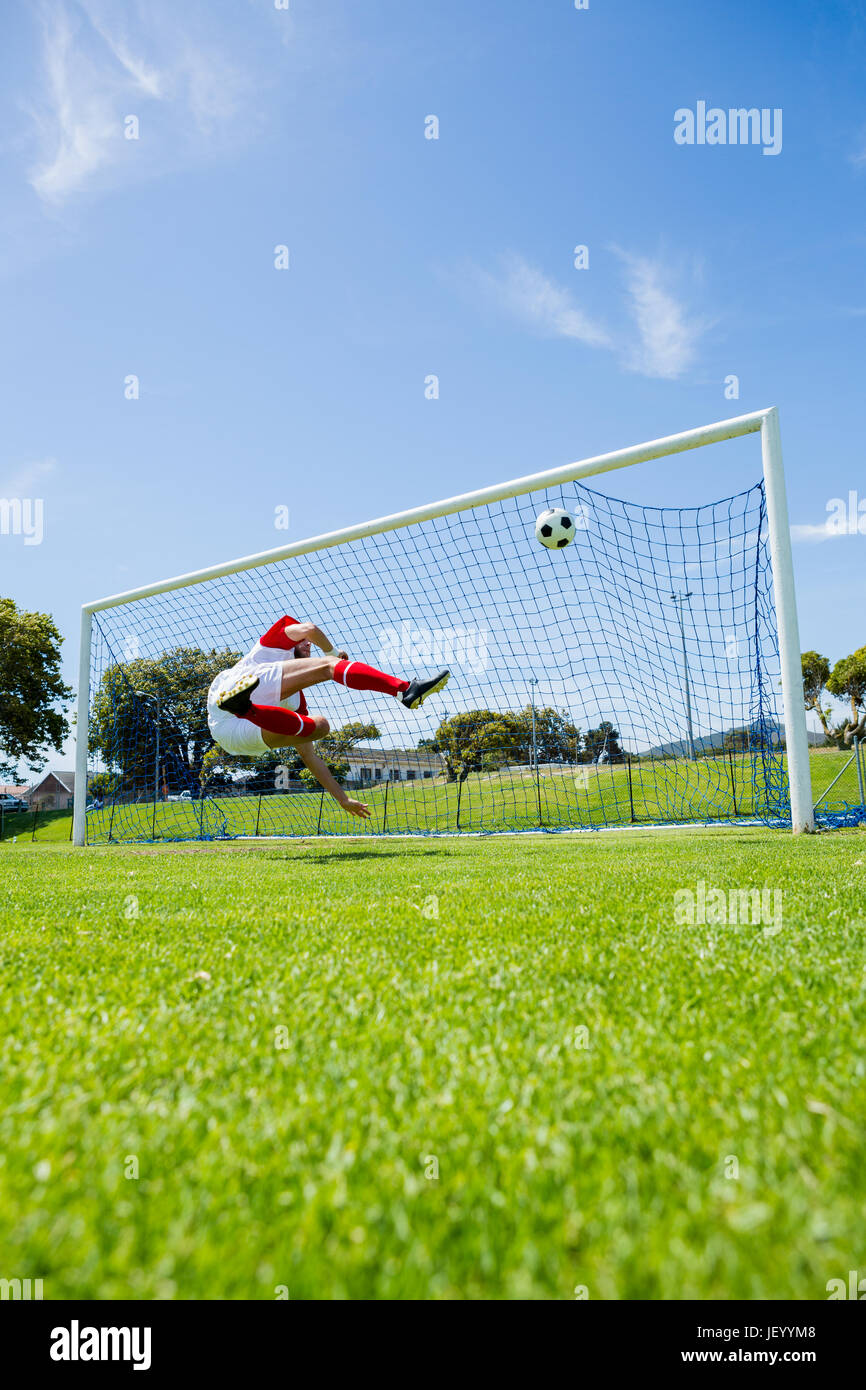 Football player scoring a goal Stock Photo - Alamy