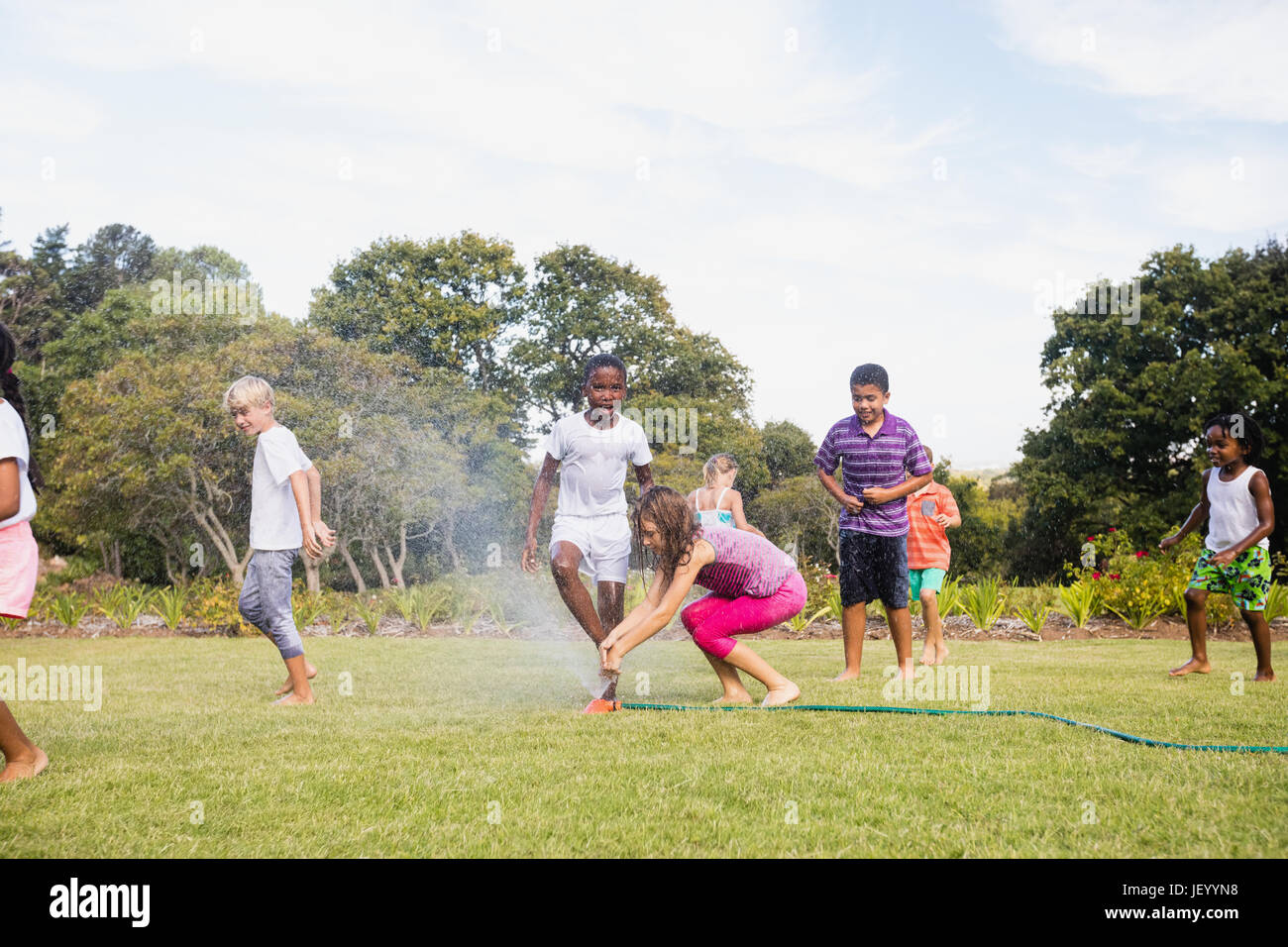 Kids playing together during a sunny day Stock Photo - Alamy