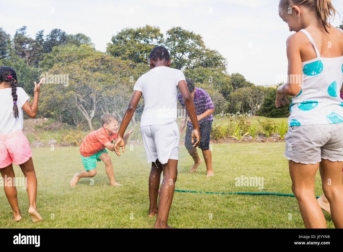 Kids playing together during a sunny day Stock Photo - Alamy