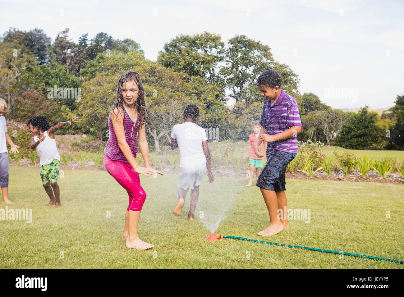 Kids playing together during a sunny day Stock Photo - Alamy