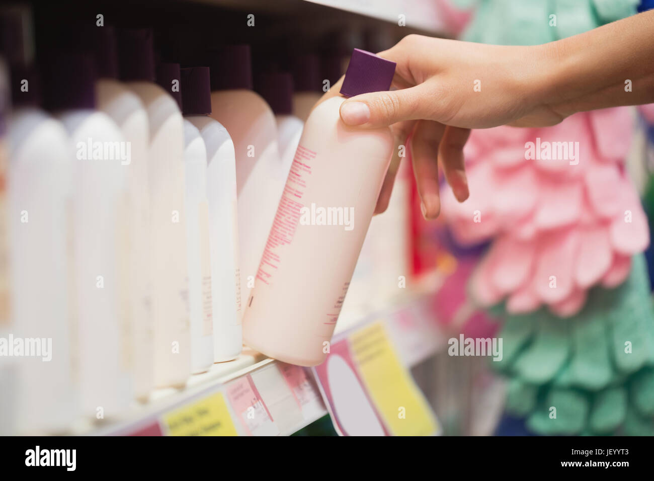 Focus on hands picking shampoo Stock Photo - Alamy