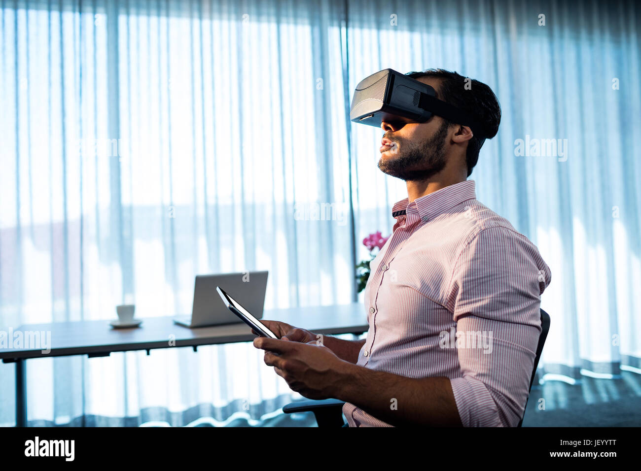 Businessman using an oculus Stock Photo - Alamy