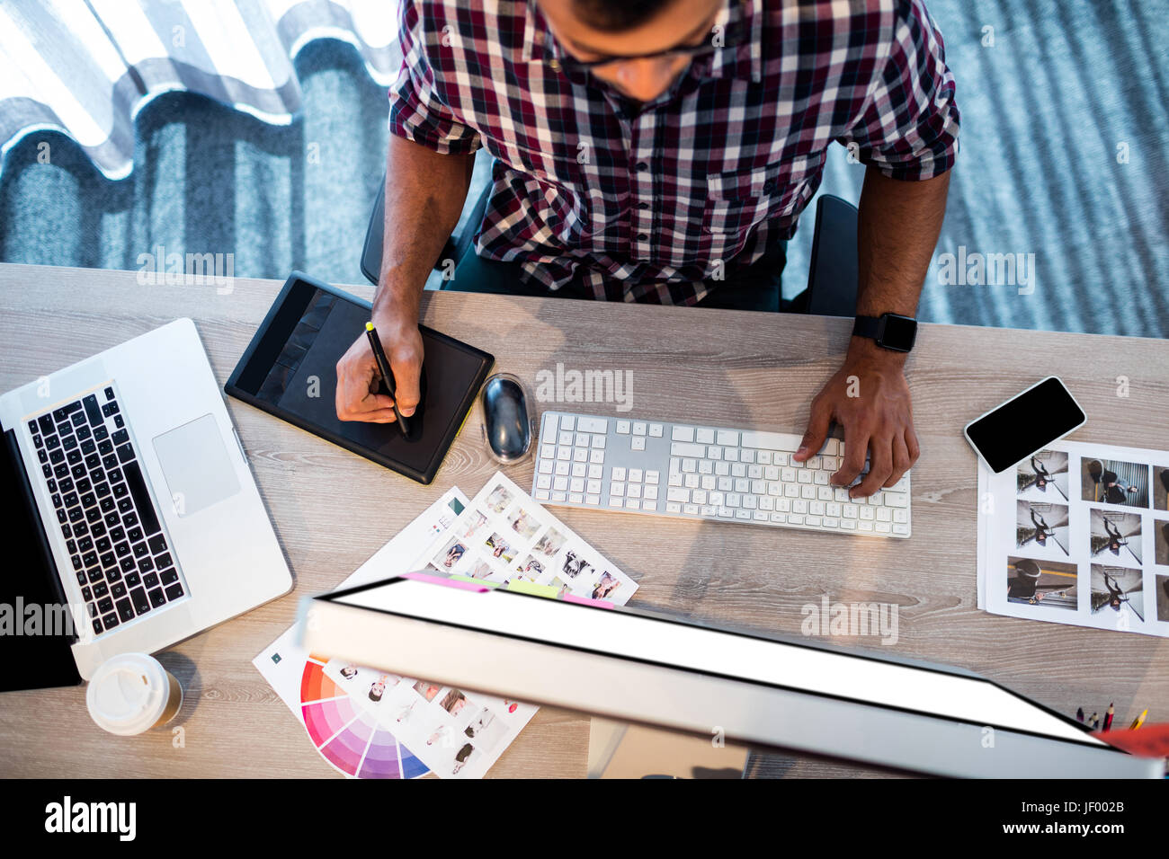 Overhead view of casual man working at desk Stock Photo - Alamy