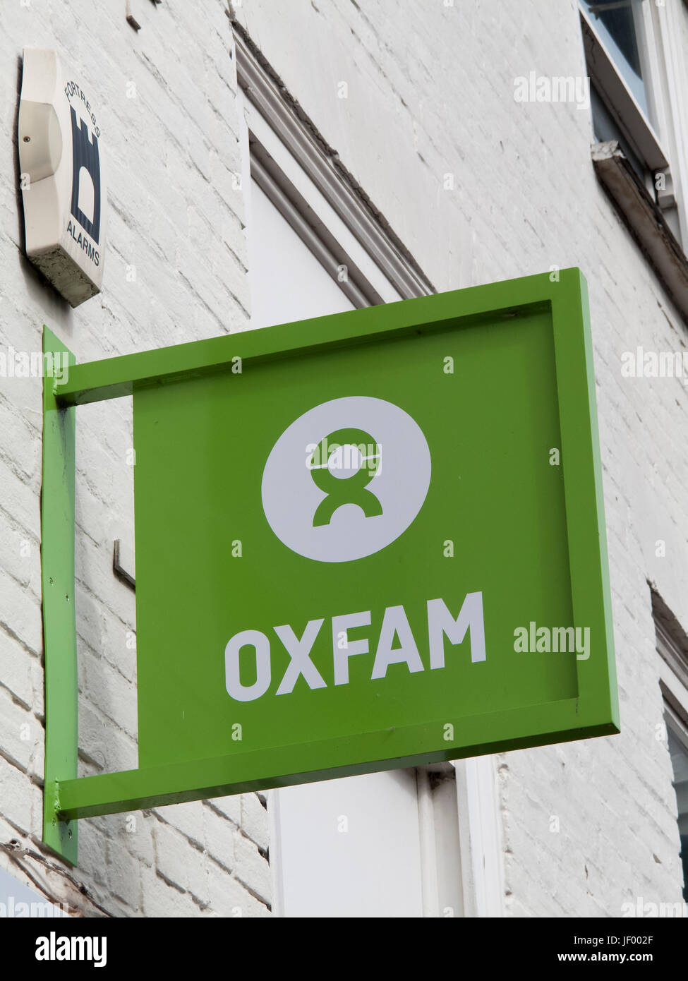 Oxfam charity shop sign over retail store, finding solutions to poverty ...