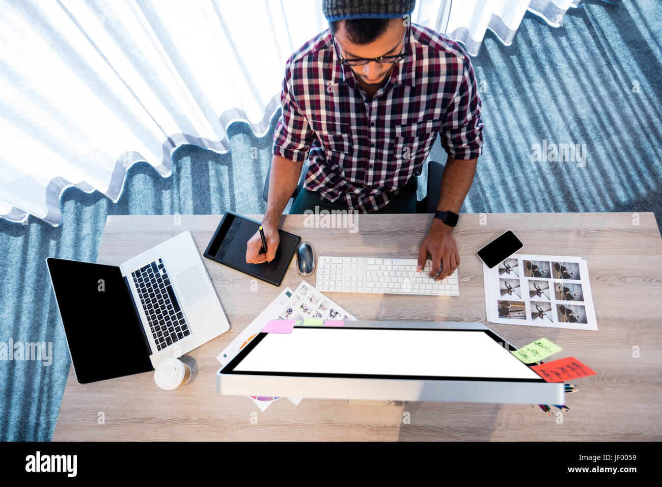 Overhead view of casual man working at desk Stock Photo - Alamy