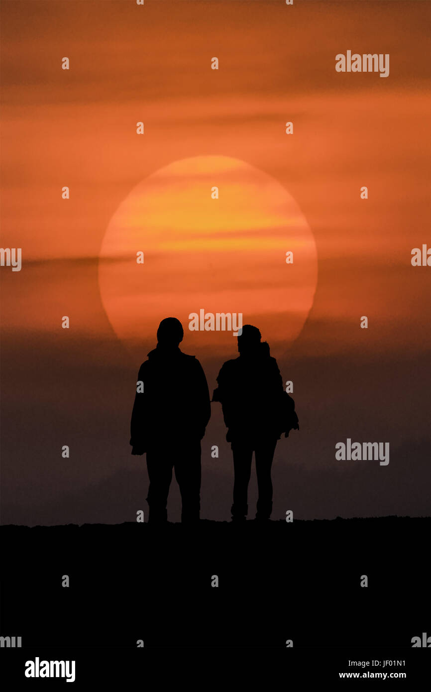 Two people watching orange sunset hi-res stock photography and images ...
