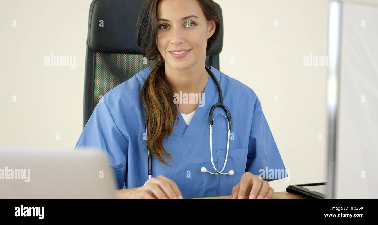 Beautiful female doctor at laptop computer Stock Photo - Alamy