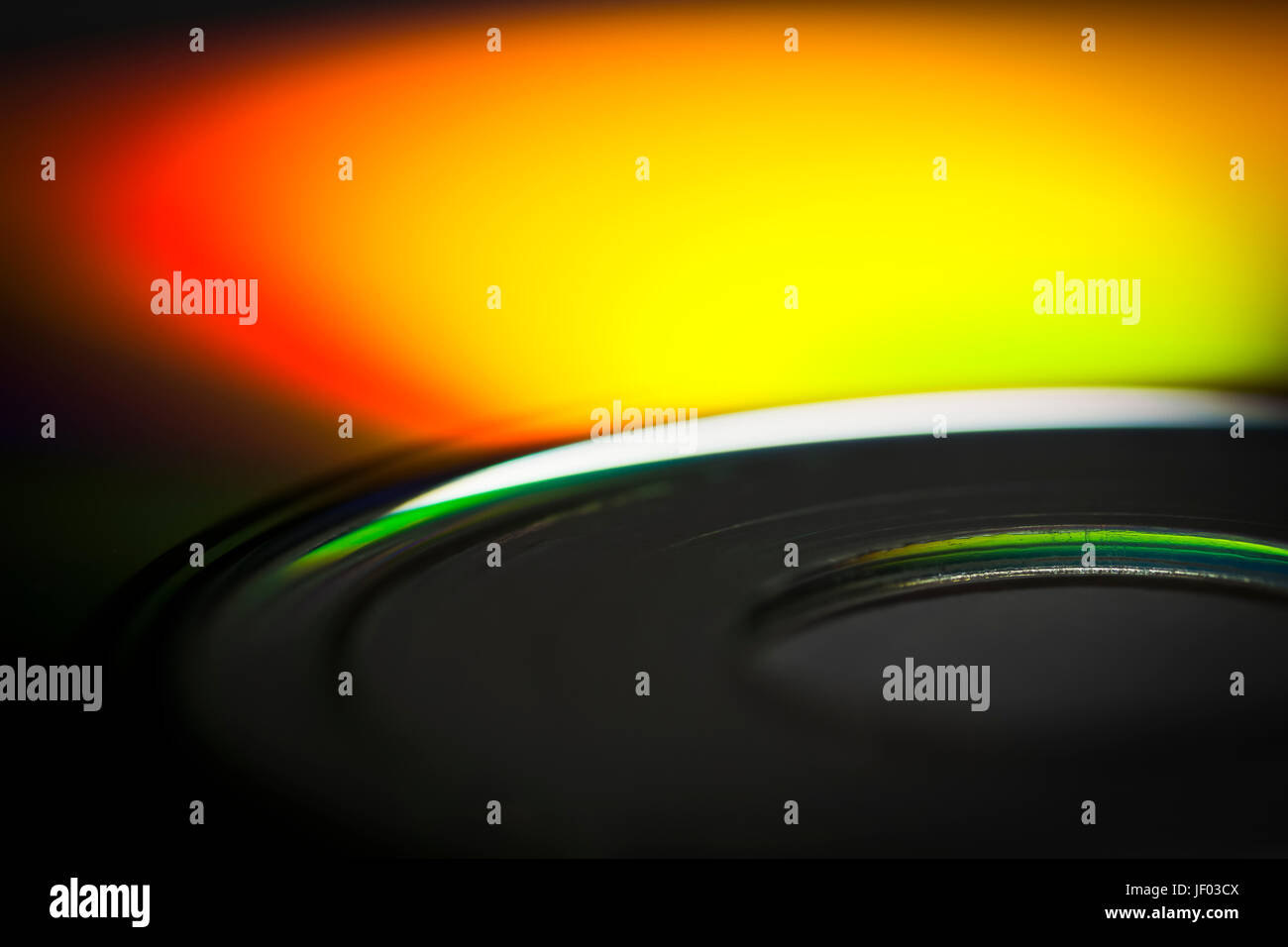 The surface of the CD close-up reflects the spectral colors Stock Photo ...