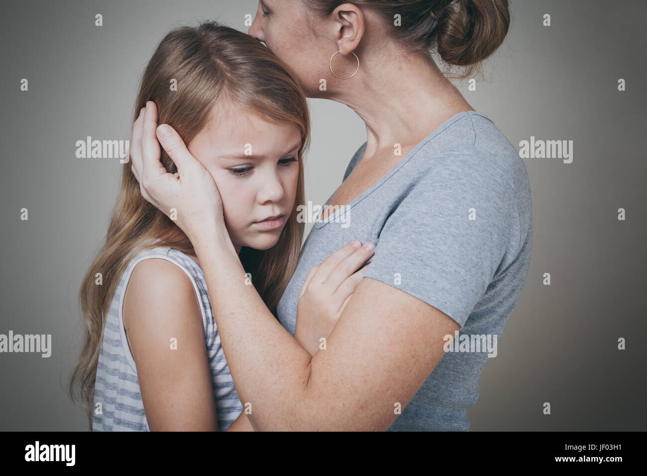 Mother And Daughter Hugging Sad