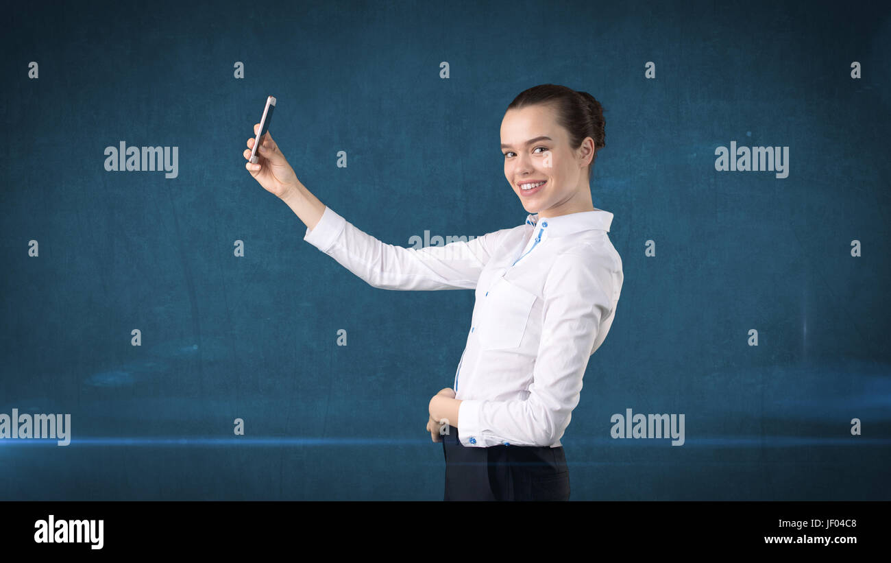 Beautiful office woman in white skirt smiling at her mobe phone ...