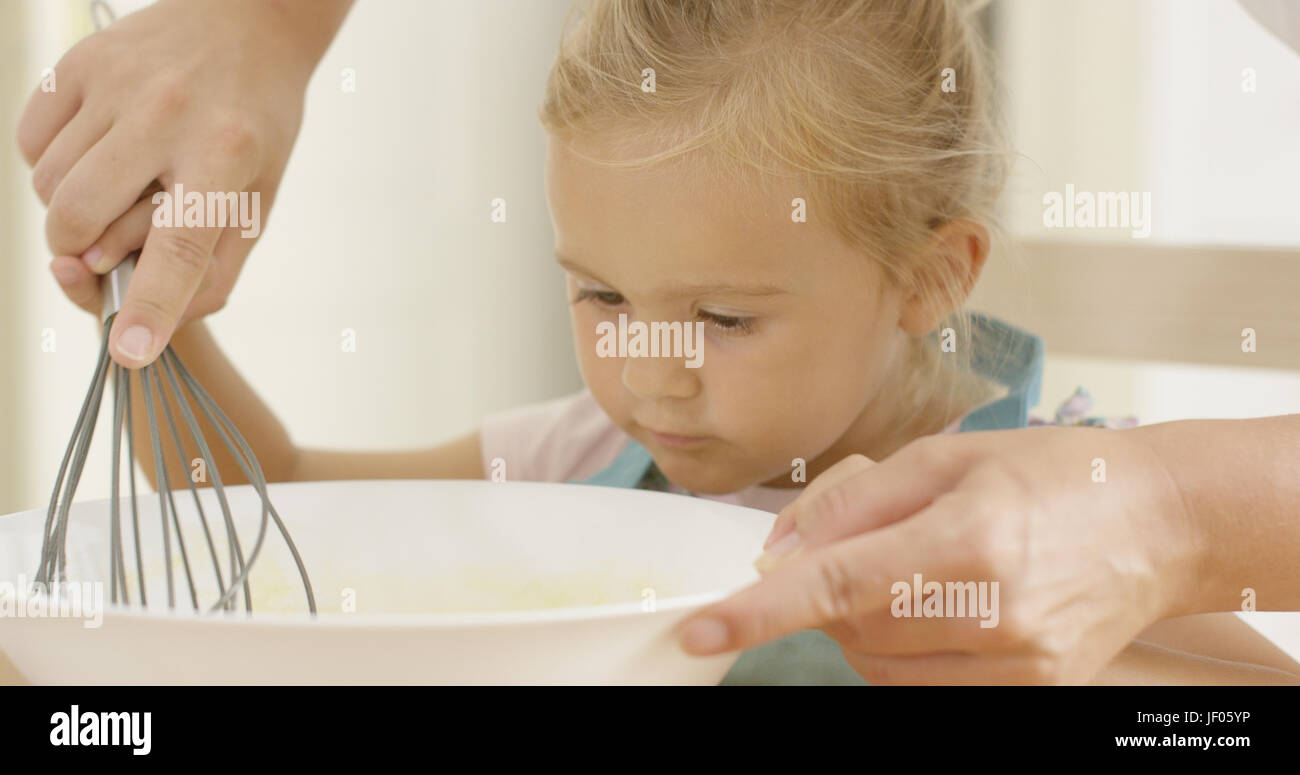 Fascinated little girl learning to bake Stock Photo - Alamy