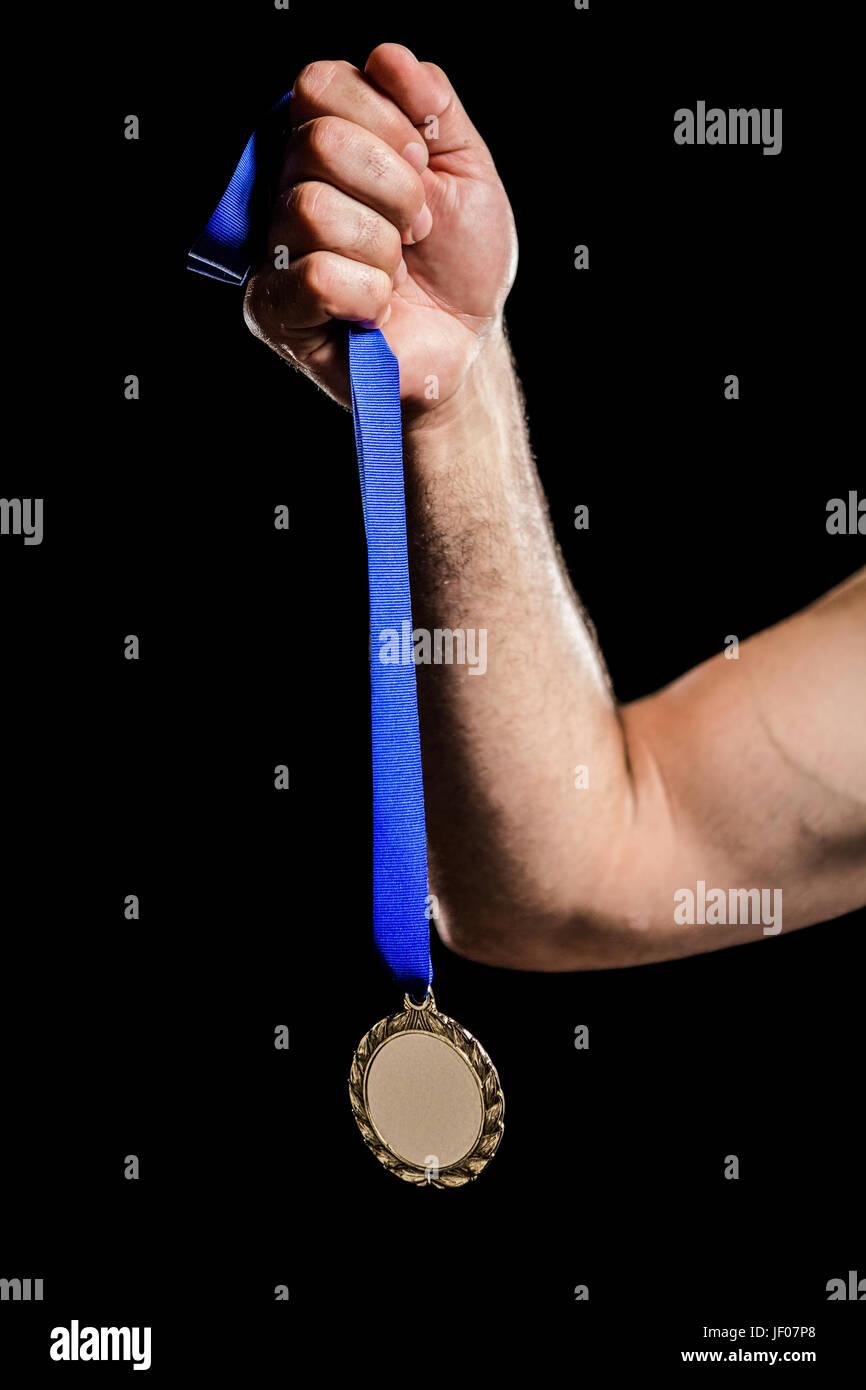 Hand holding olympic gold medal Stock Photo - Alamy