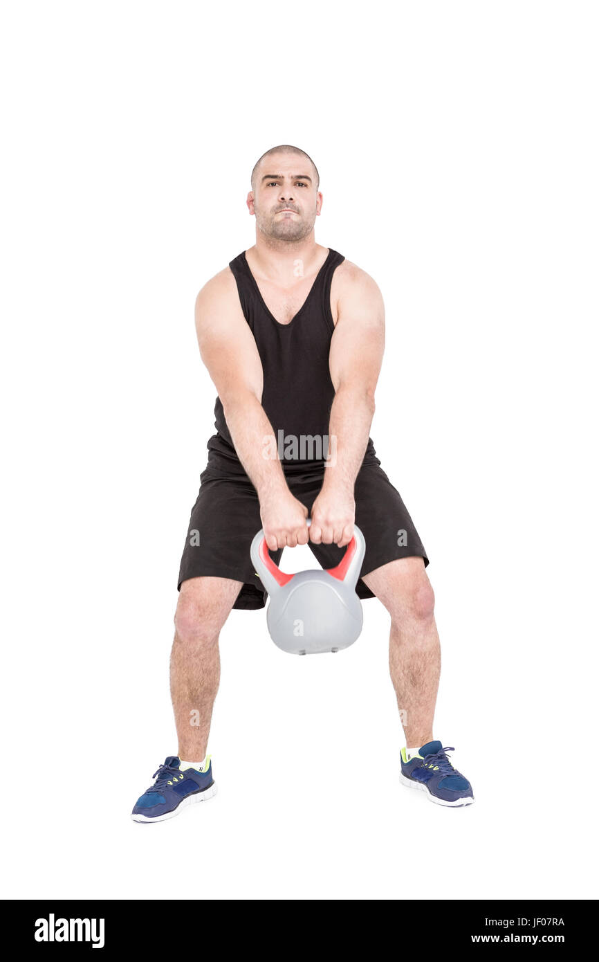Bodybuilder lifting heavy kettlebell Stock Photo - Alamy