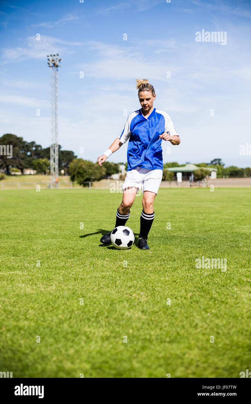Female football player practicing soccer Stock Photo - Alamy