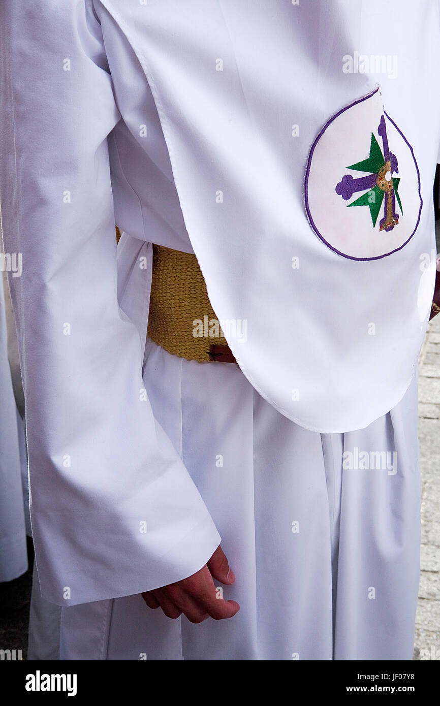 Detail of a white tunic with coat of arms of the brotherhood and belt ...