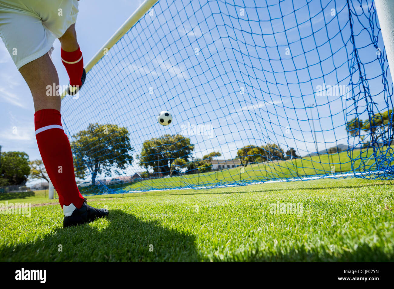 Football player scoring a goal Stock Photo - Alamy
