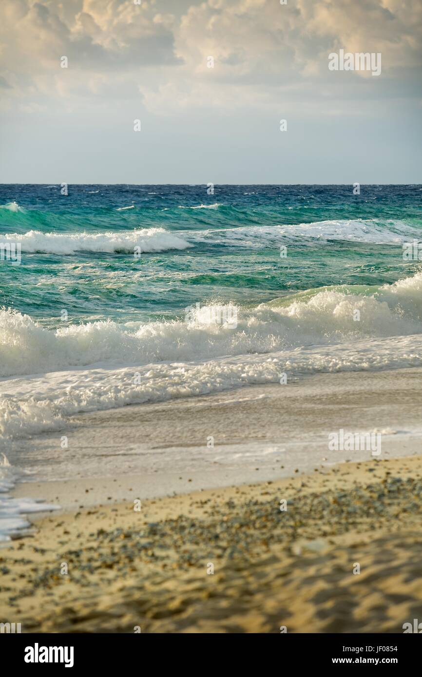 Empty beach with restless seas Stock Photo - Alamy
