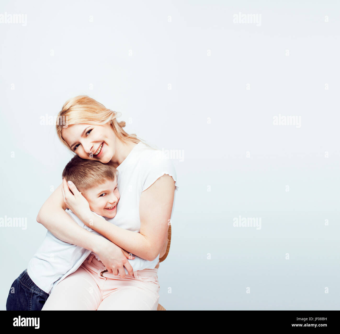 young modern blond curly mother with cute son together happy smiling ...