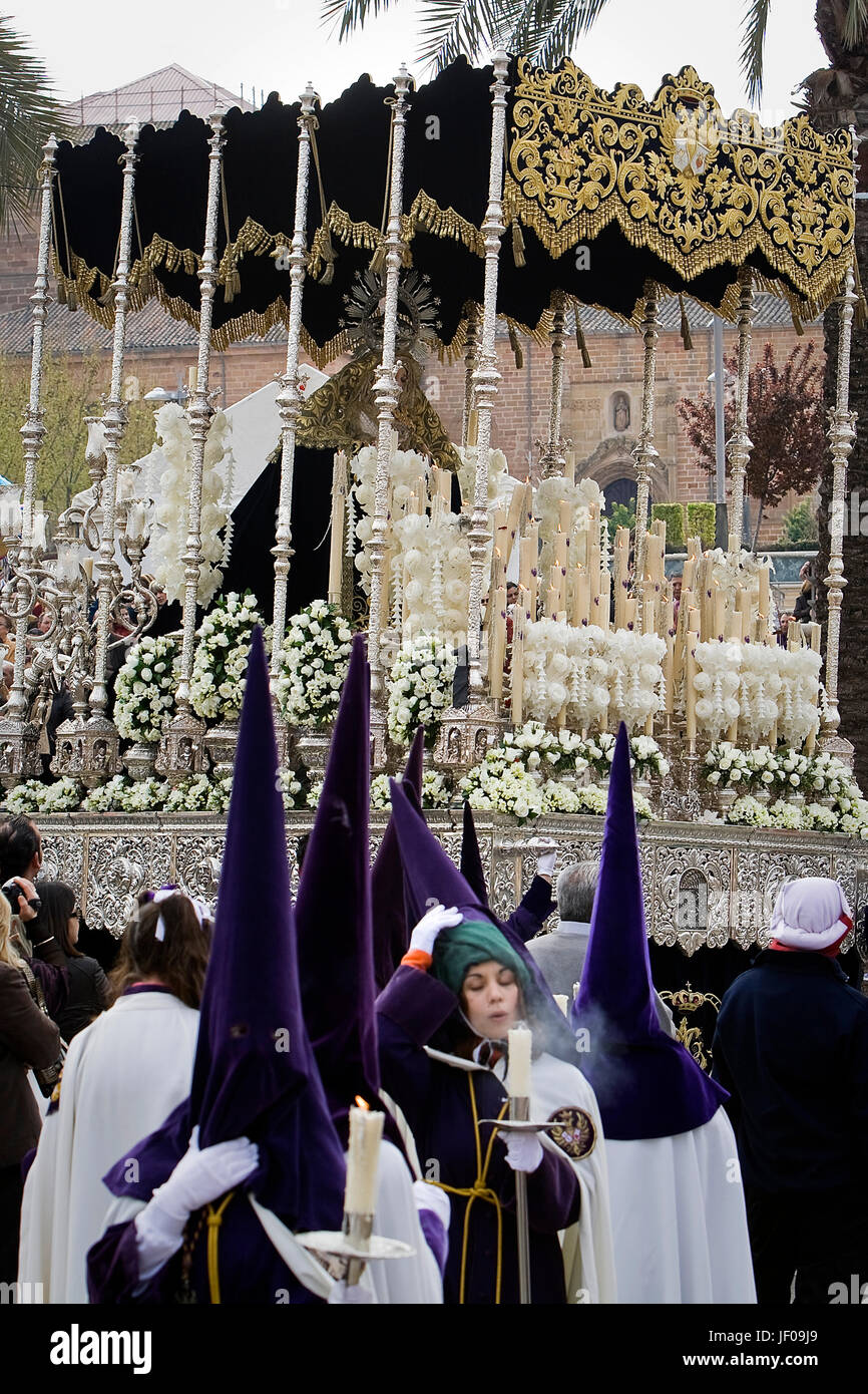 Detail penitent white holding a candle during Holy Week, Spain Stock ...