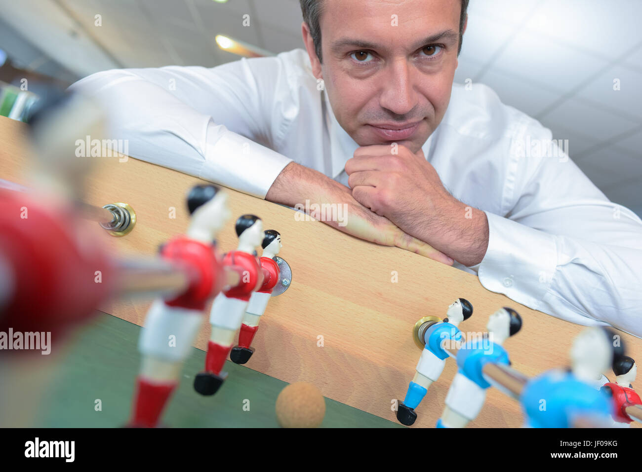 man sells table football in store Stock Photo - Alamy