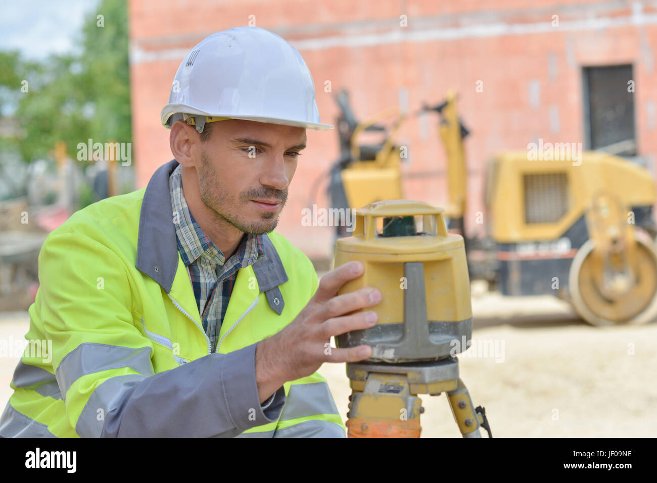 Surveyor on building site Stock Photo - Alamy