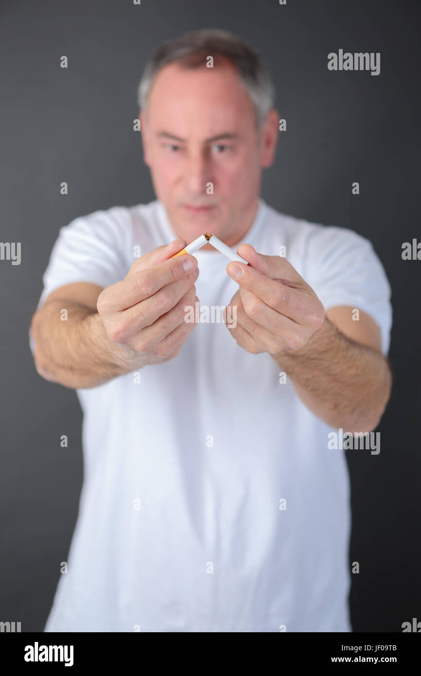 Breaking cigarette mature hi-res stock photography and images - Alamy