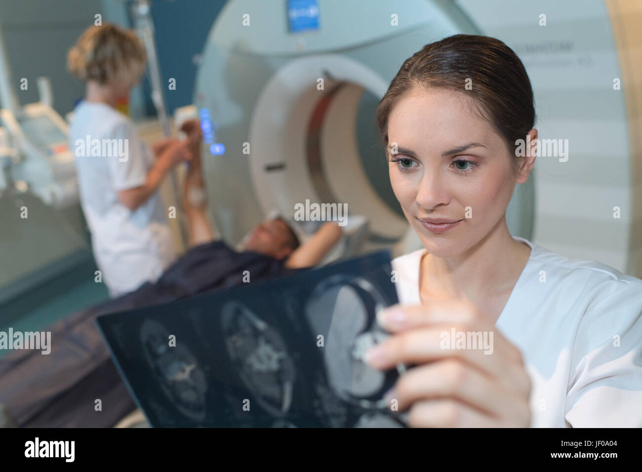 Medical worker examining mri scan results Stock Photo - Alamy