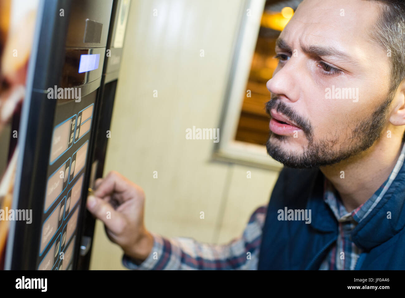 man choosing drink from vending machine Stock Photo - Alamy