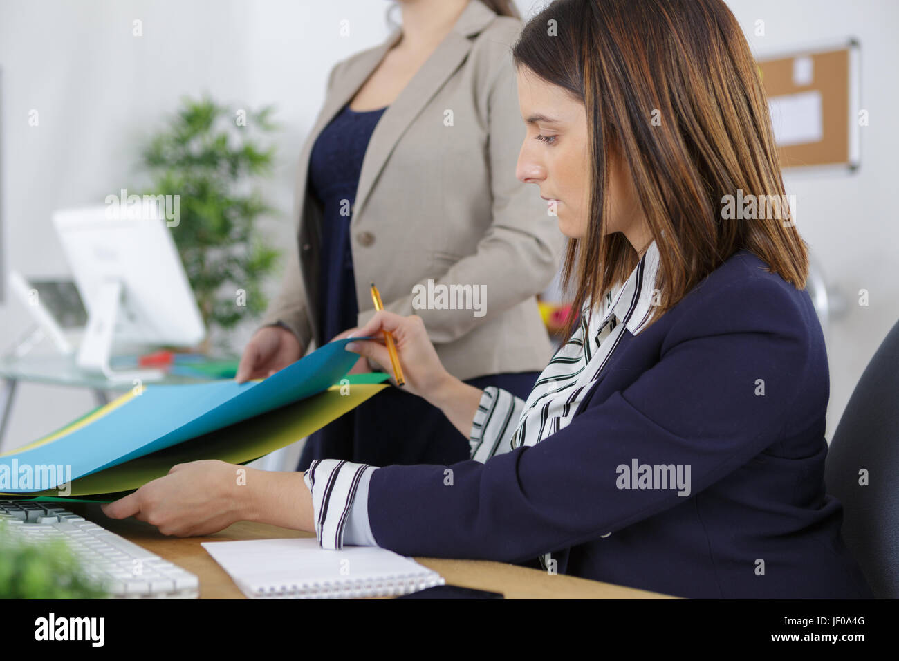female office worker getting papers Stock Photo - Alamy