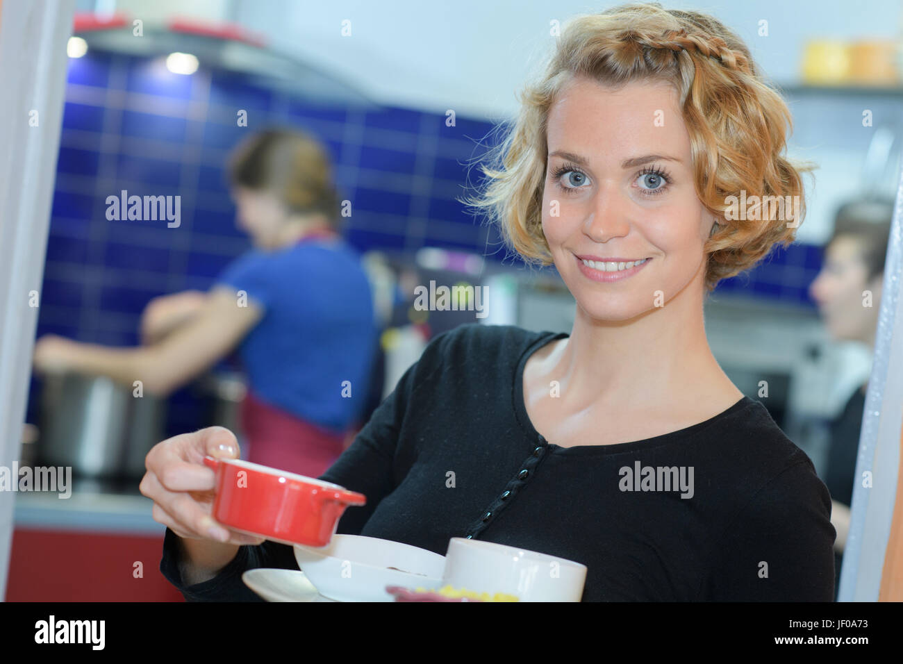 Woman carrying dish hi-res stock photography and images - Alamy