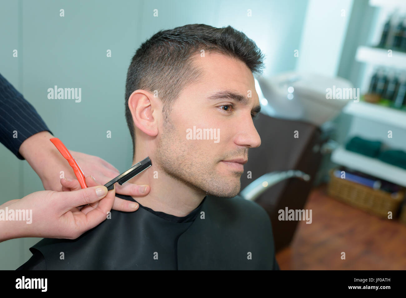 Barber giving man a trim Stock Photo - Alamy