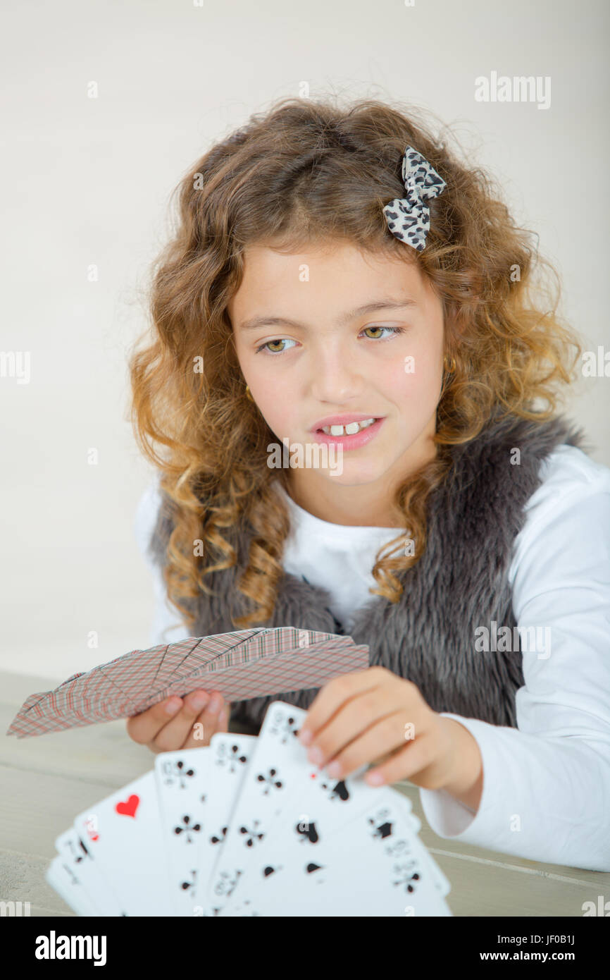 Schoolgirl playing cards Stock Photo - Alamy