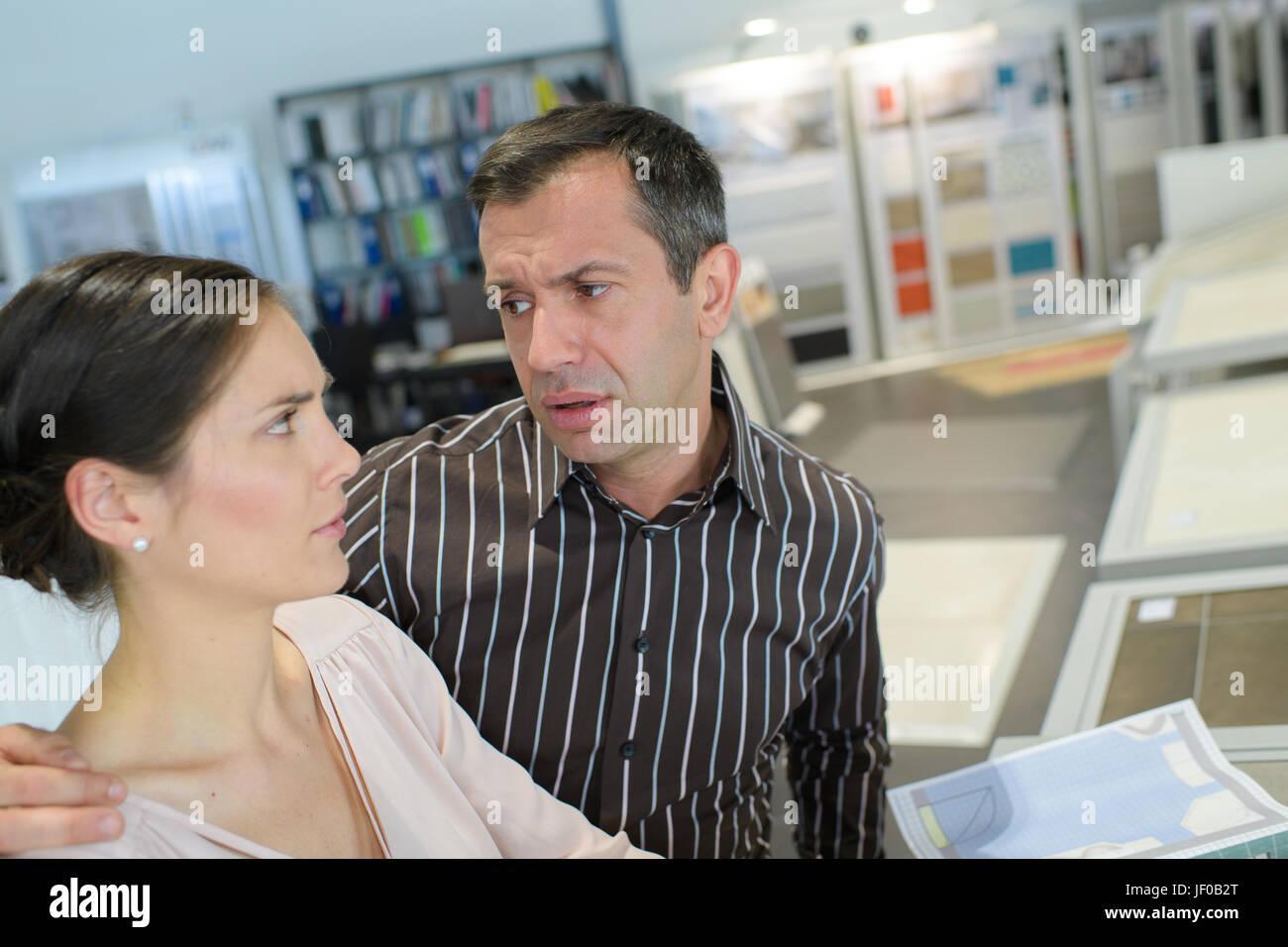 Man making pitiful expression at woman Stock Photo - Alamy