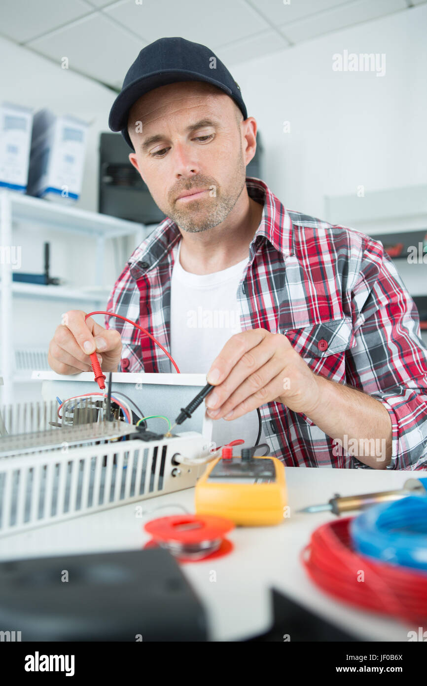 Technician using multimeter Stock Photo - Alamy