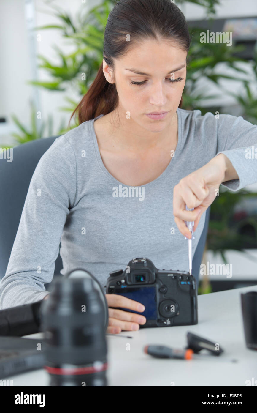 Woman working on camera Stock Photo - Alamy
