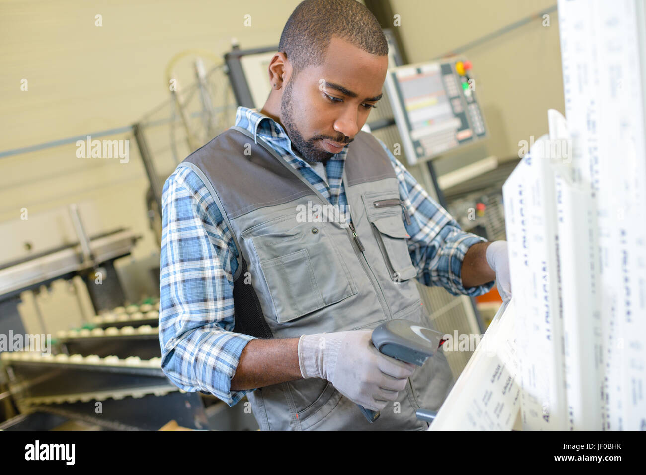 Factory worker using scanner Stock Photo - Alamy