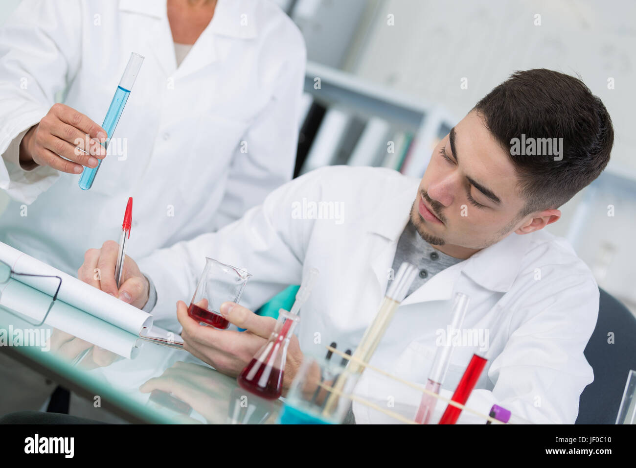 Scientists performing an experiment Stock Photo - Alamy