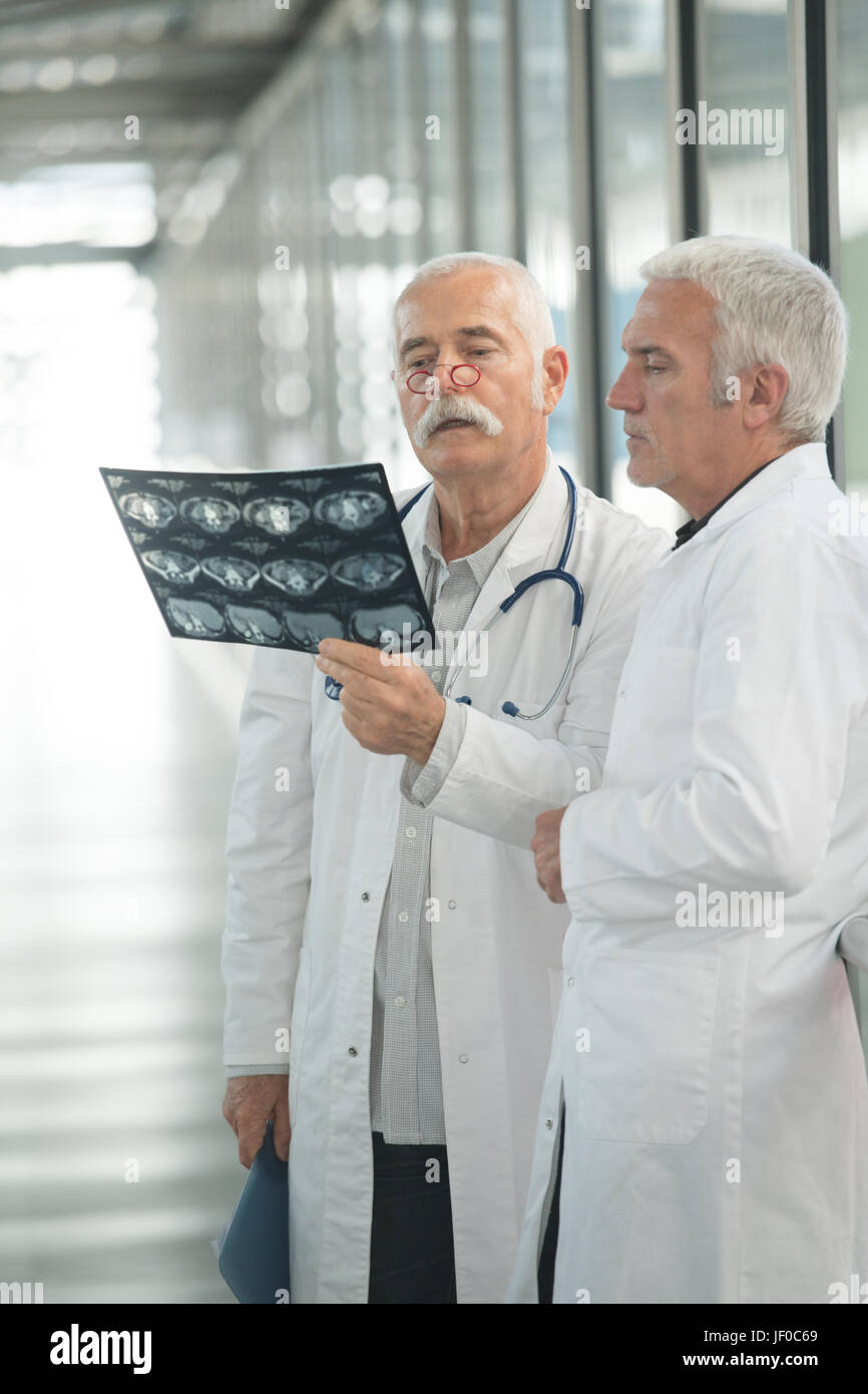 Two senior doctors looking at xrays Stock Photo - Alamy
