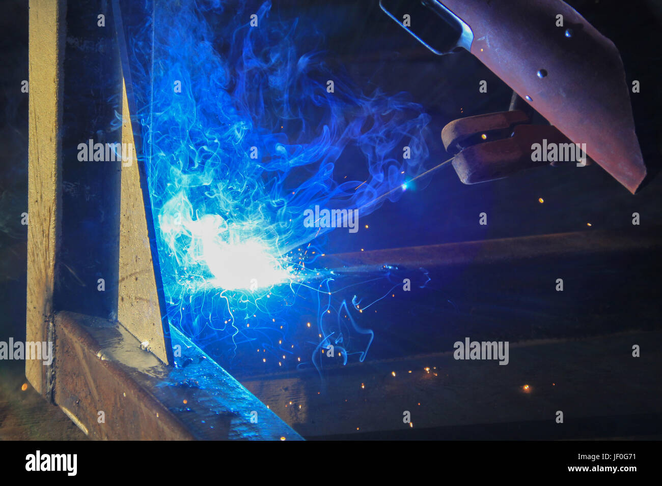 welding steel iron with blue smoke Stock Photo - Alamy
