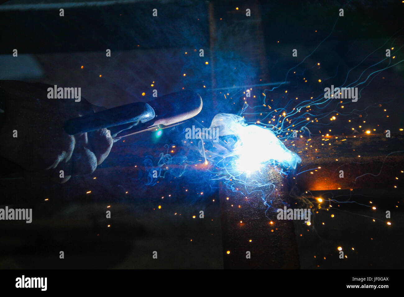 welding steel with sparks lighting Stock Photo - Alamy