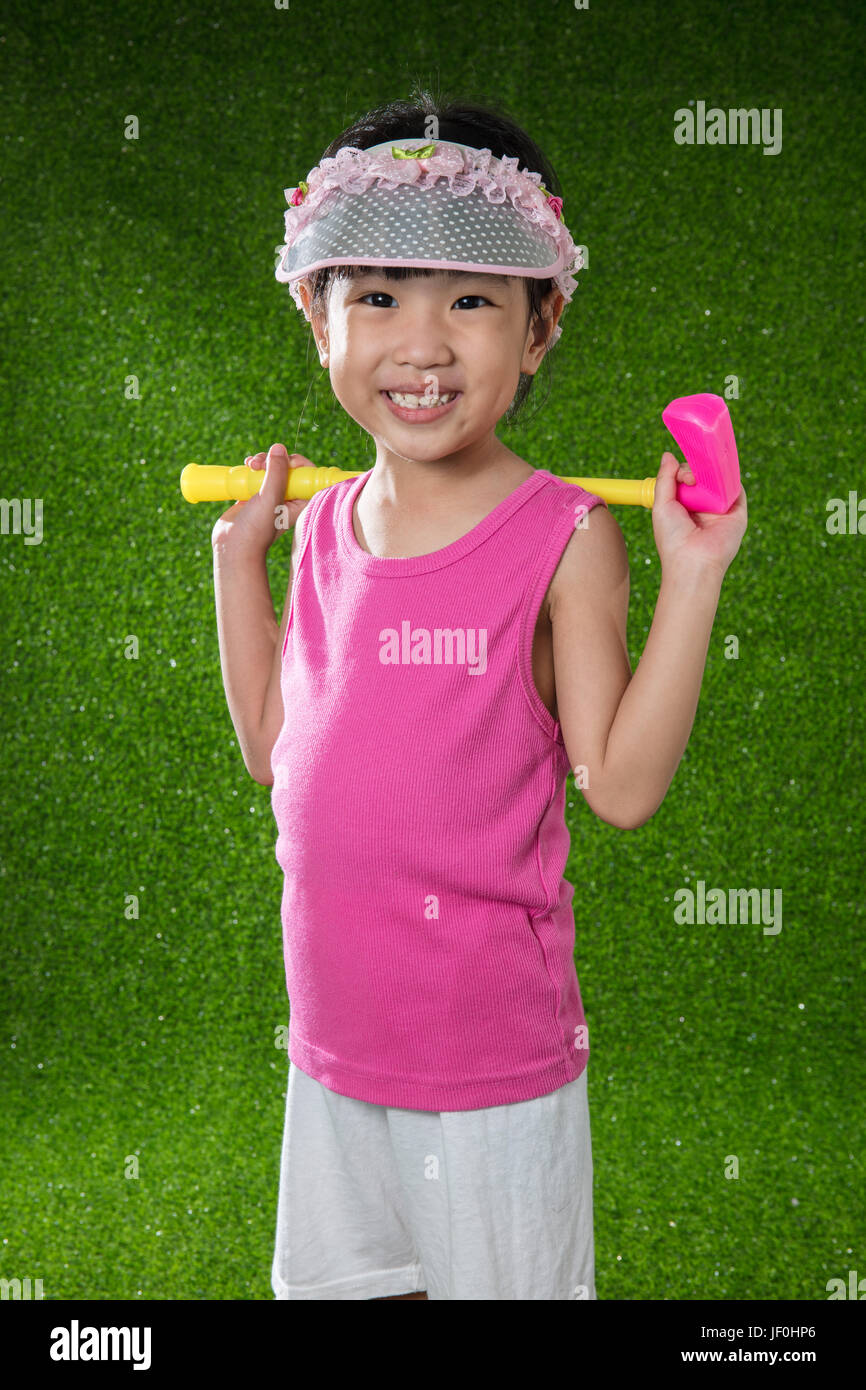 Asian Chinese little girl playing golf on green grass Stock Photo - Alamy